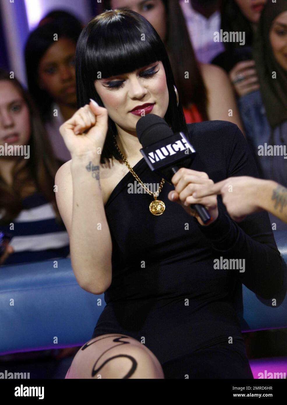 Wearing a black unitard with one black leg and a white one with a black ...