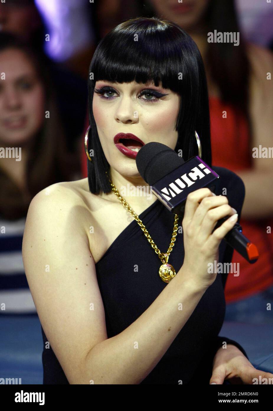 Wearing a black unitard with one black leg and a white one with a black ...