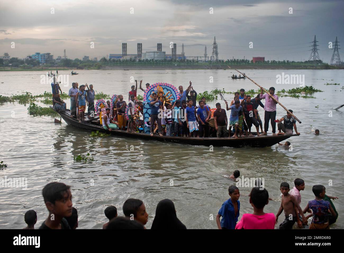 Bangladesh Hindu devotees carry an idol of Goddess Durga on a boat for ...