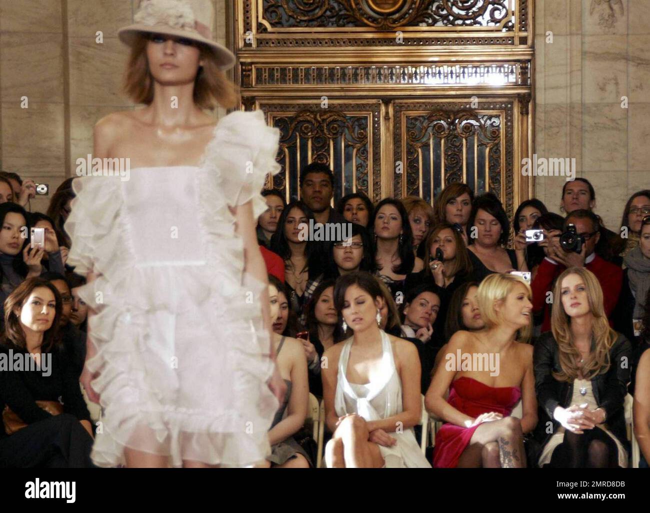 As one model at the Jill Stuart fashion show walks by with a see ...