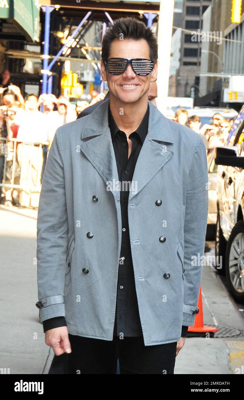 Jim Carrey wears some funky slatted sunglasses as he poses for photos ...