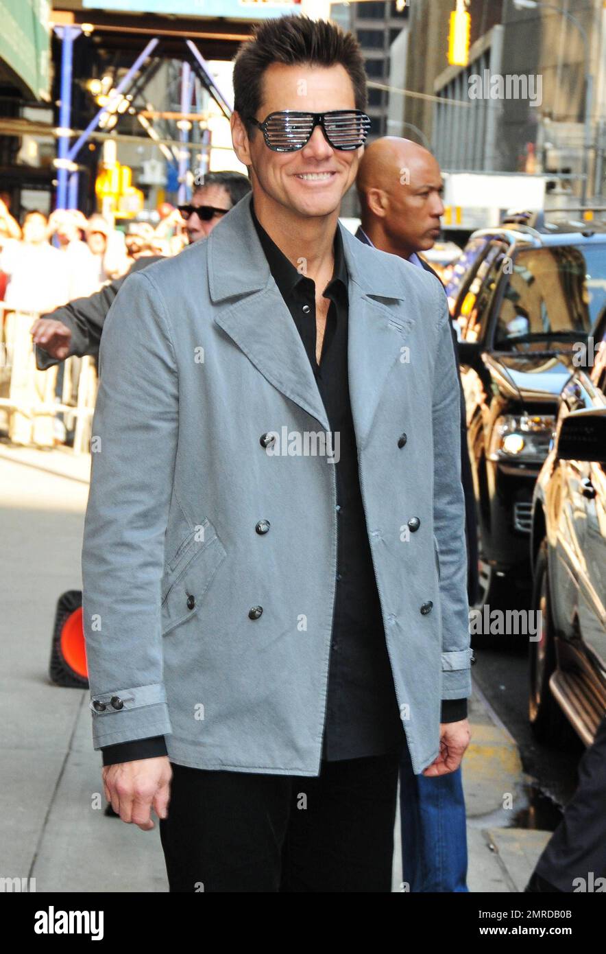 Jim Carrey Wears Some Funky Slatted Sunglasses As He Poses For Photos Outside The Late Show