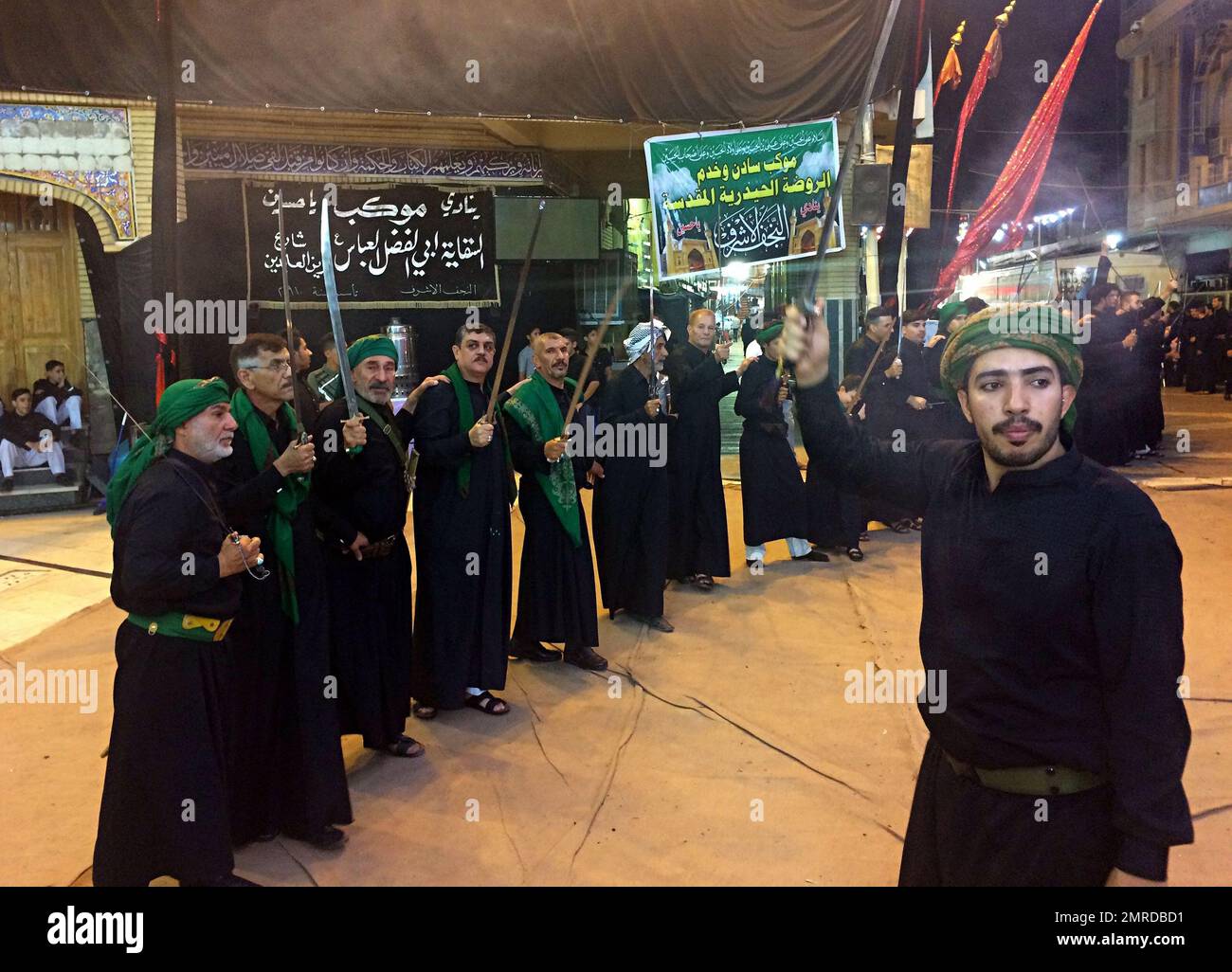Iraqi Shiite faithful take part in a Muharram procession in Najaf, 100 ...