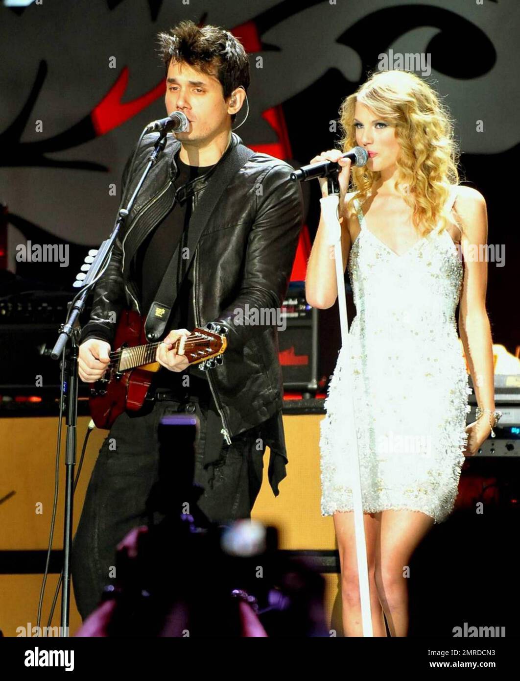 Singer John Mayer is joined by Taylor Swift on stage at the Z100 Jingle ...