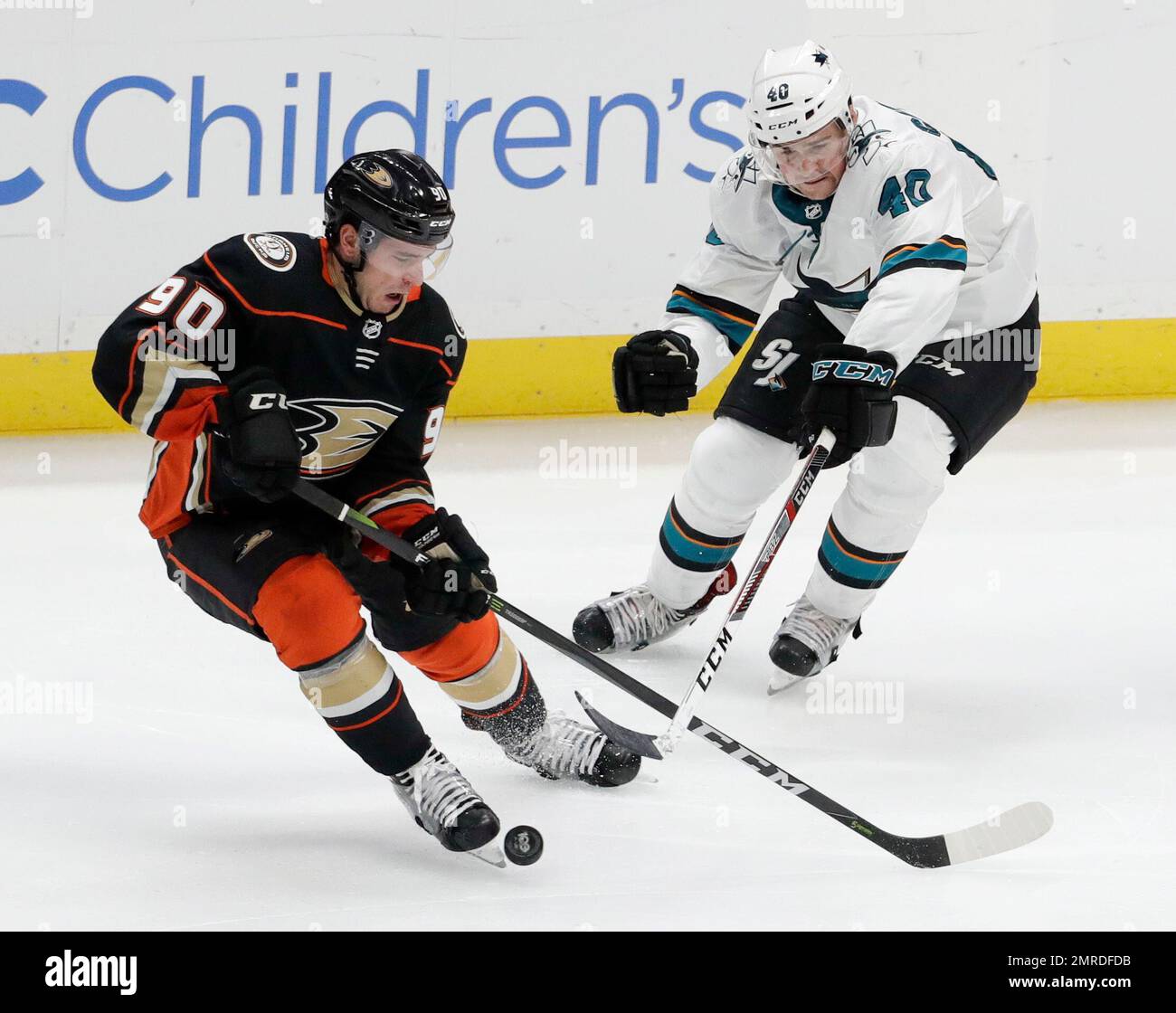 San Jose Sharks center Ryan Carpenter, right, knocks the puck away from ...