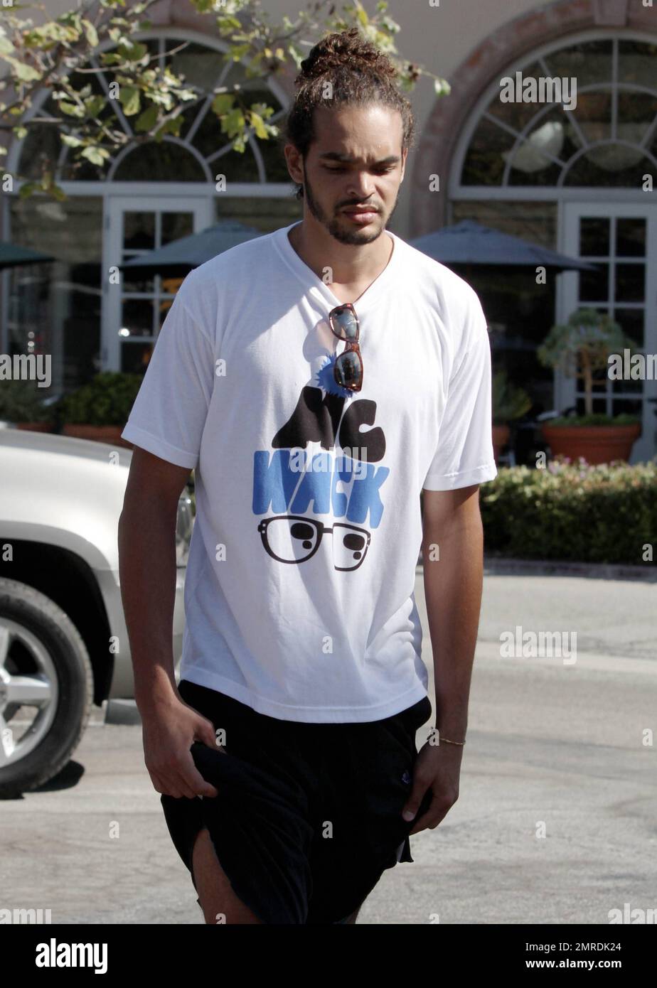 Joakim Noah of the Chicago Bulls holds up the legs of his shorts as he ...