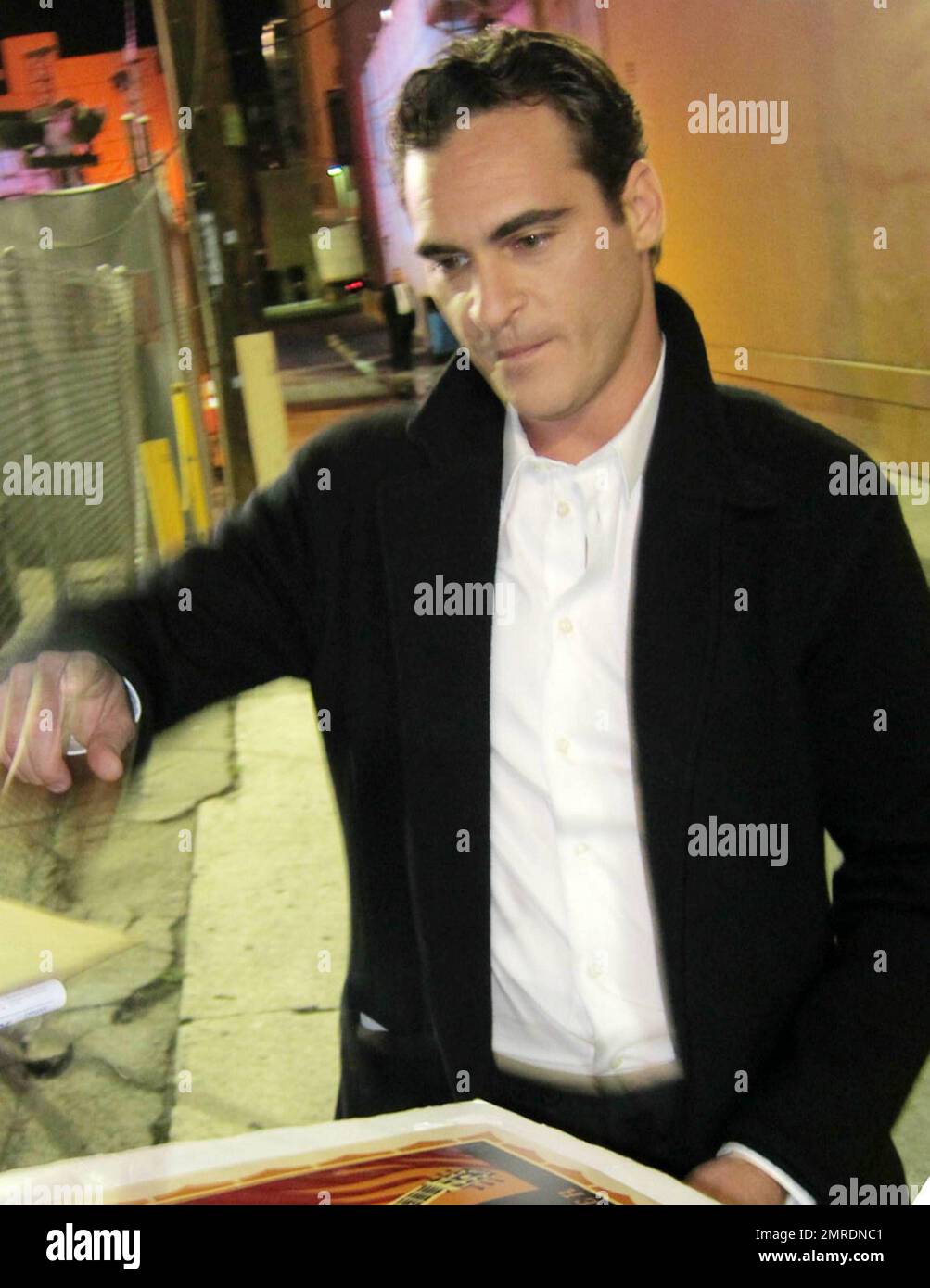 Freshly shaven actor Joaquin Phoenix signs autographs for fans as he ...