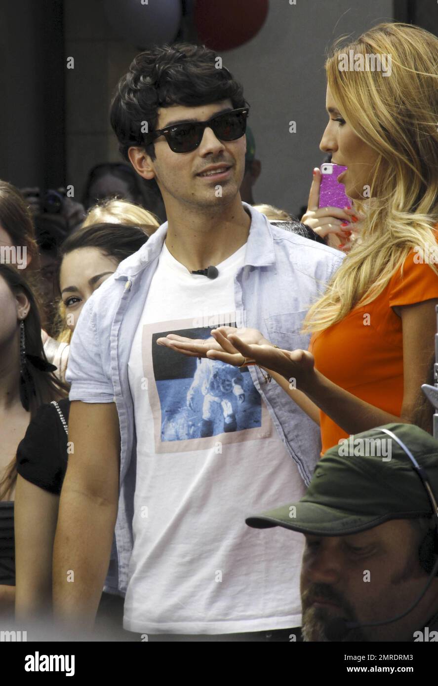 Singer Joe Jonas is presented with a birthday cake featuring an image ...