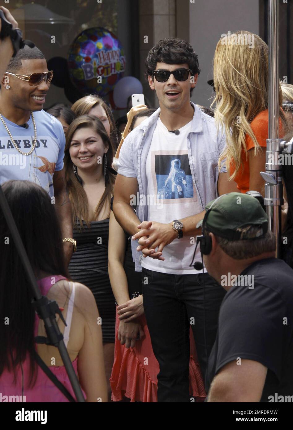 Singer Joe Jonas is presented with a birthday cake featuring an image ...