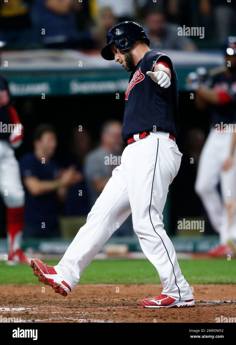 Cleveland Indians' Yan Gomes steps on home plate after hitting a solo ...