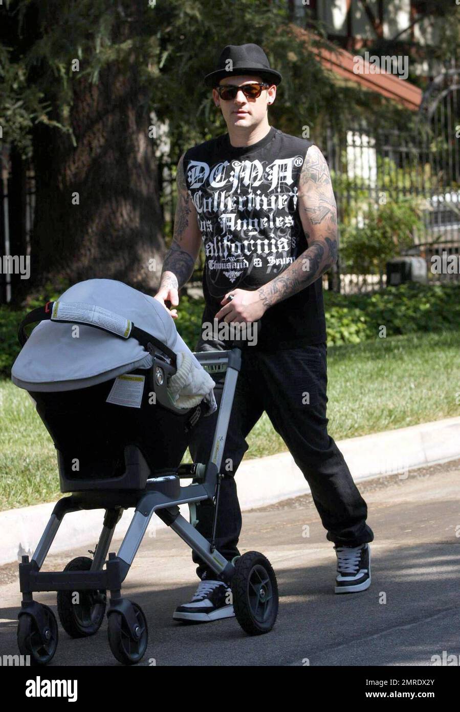 Joel Madden took baby Harlow for a walk in the stroller this morning ...