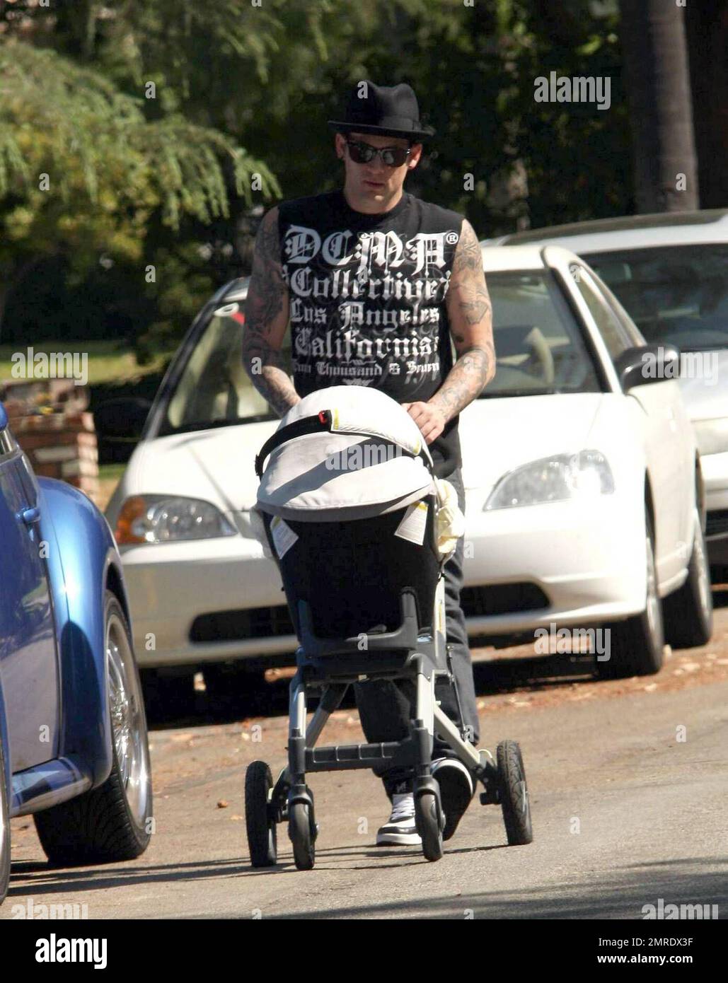 Joel Madden took baby Harlow for a walk in the stroller this morning ...