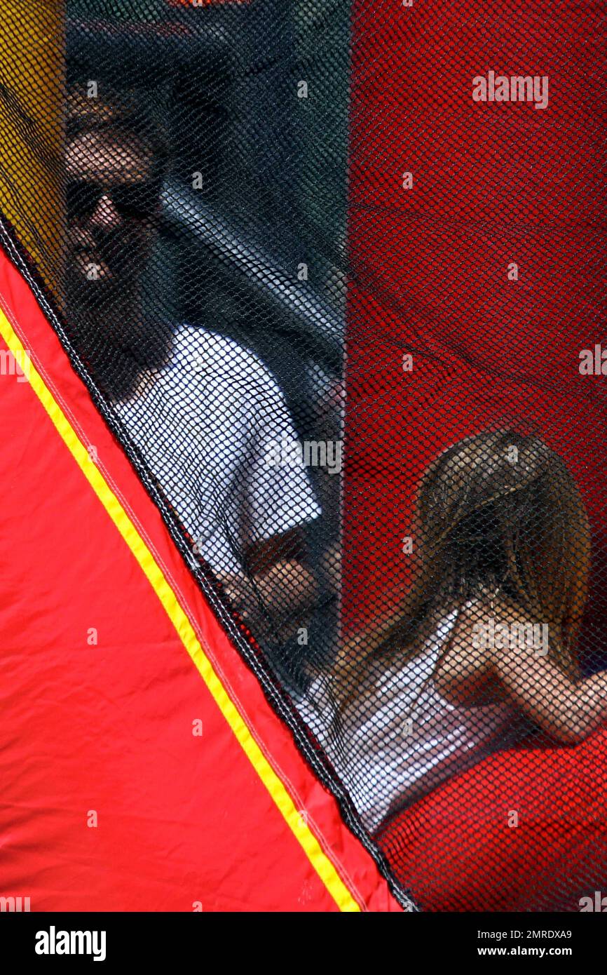 Tobey Maguire plays in the bounce house on the beach with daughter Ruby ...
