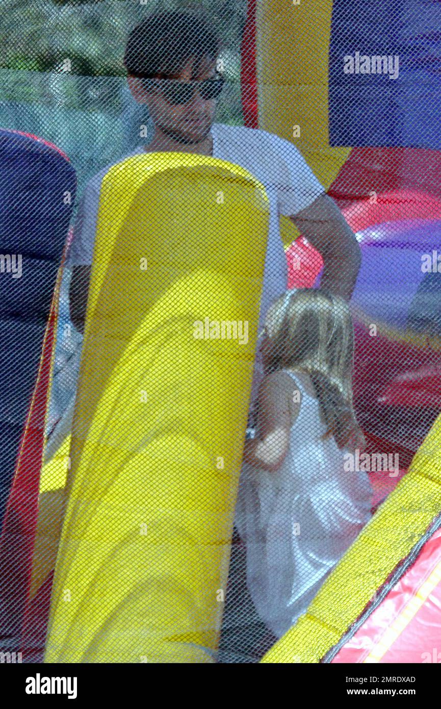 Tobey Maguire plays in the bounce house on the beach with daughter Ruby ...