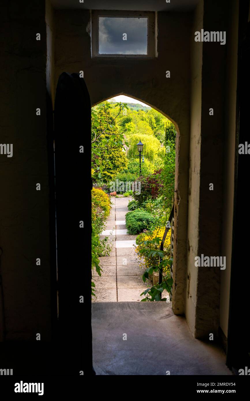 Pointed arched gate to a garden in the Cotswold town of Winchcombe ...
