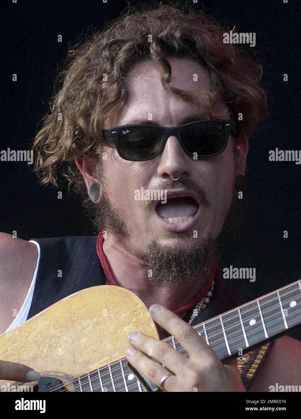 Australian musician John Butler sings and plays the guitar and bango ...