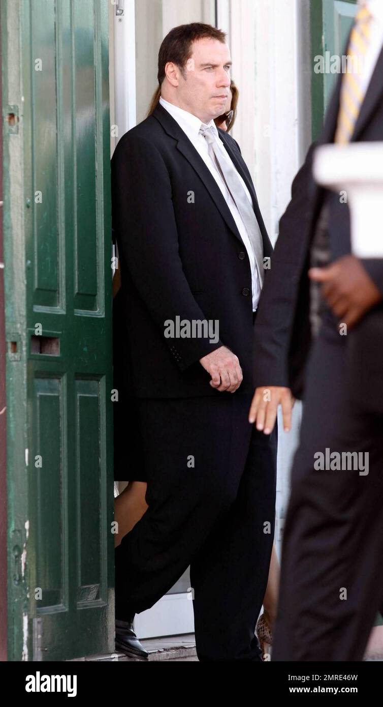 John Travolta and wife Kelly Preston look grief stricken as they leave ...