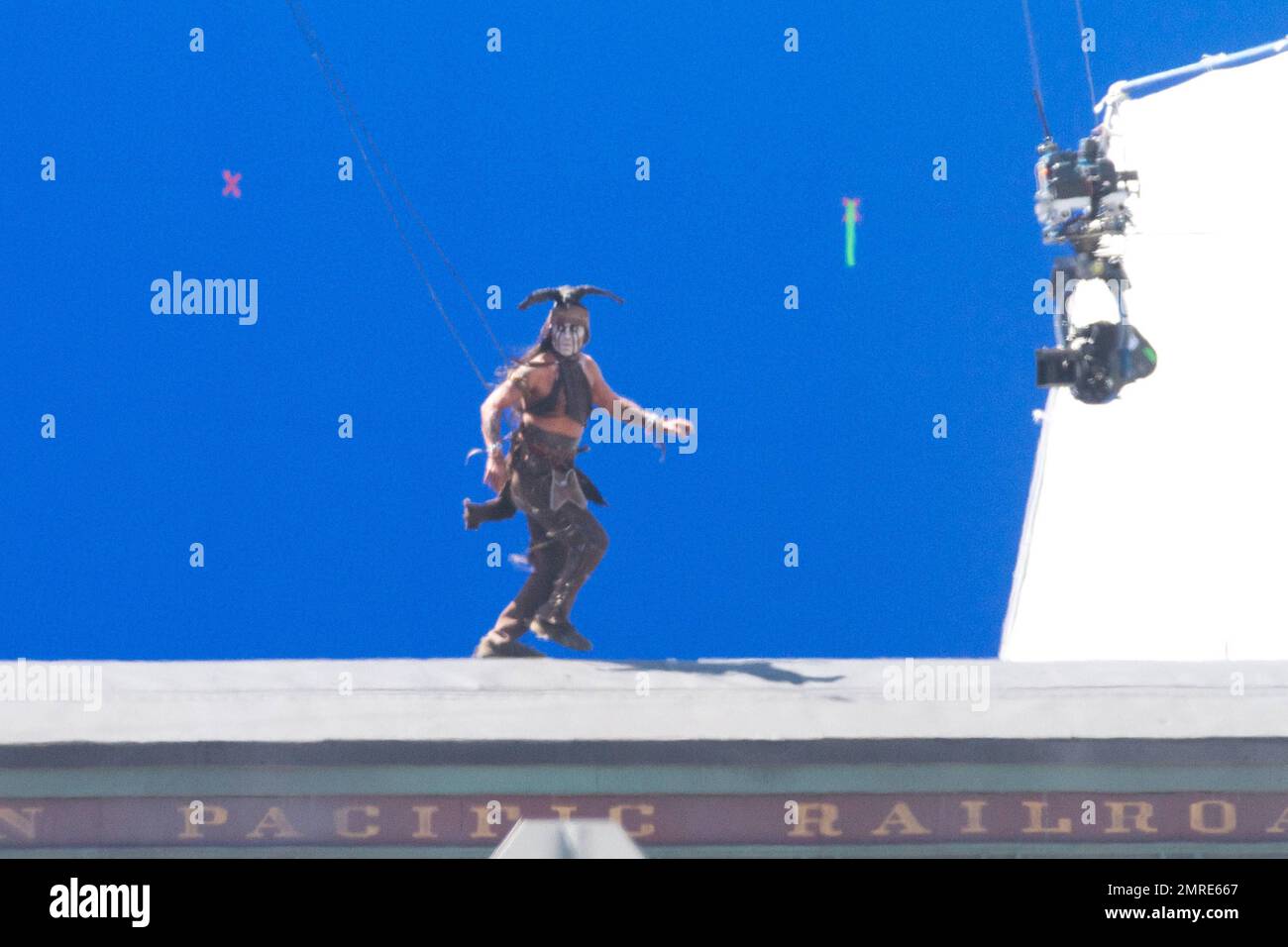 Dressed in full costume as the character Tonto, Johnny Depp shoots a ...