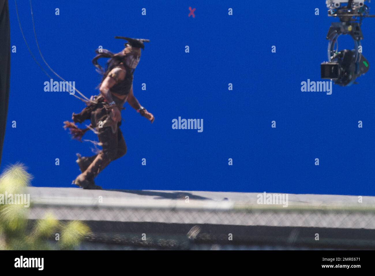 Dressed in full costume as the character Tonto, Johnny Depp shoots a ...