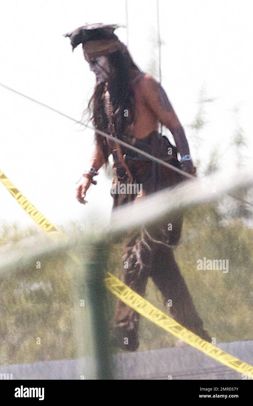 Dressed in full costume as the character Tonto, Johnny Depp shoots a ...