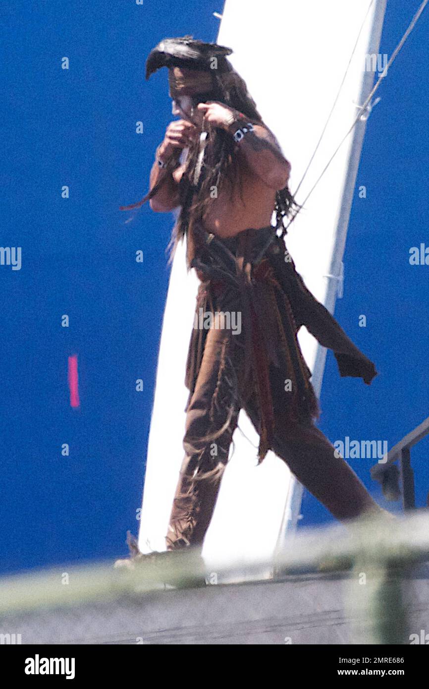 Dressed in full costume as the character Tonto, Johnny Depp shoots a ...