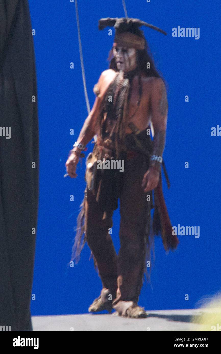 Dressed in full costume as the character Tonto, Johnny Depp shoots a ...