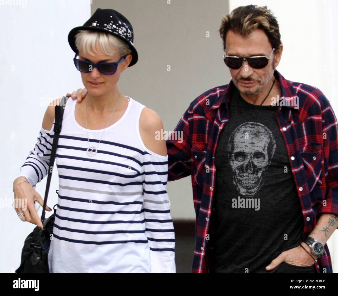 French singer and actor Johnny Hallyday strolls with wife Laeticia ...