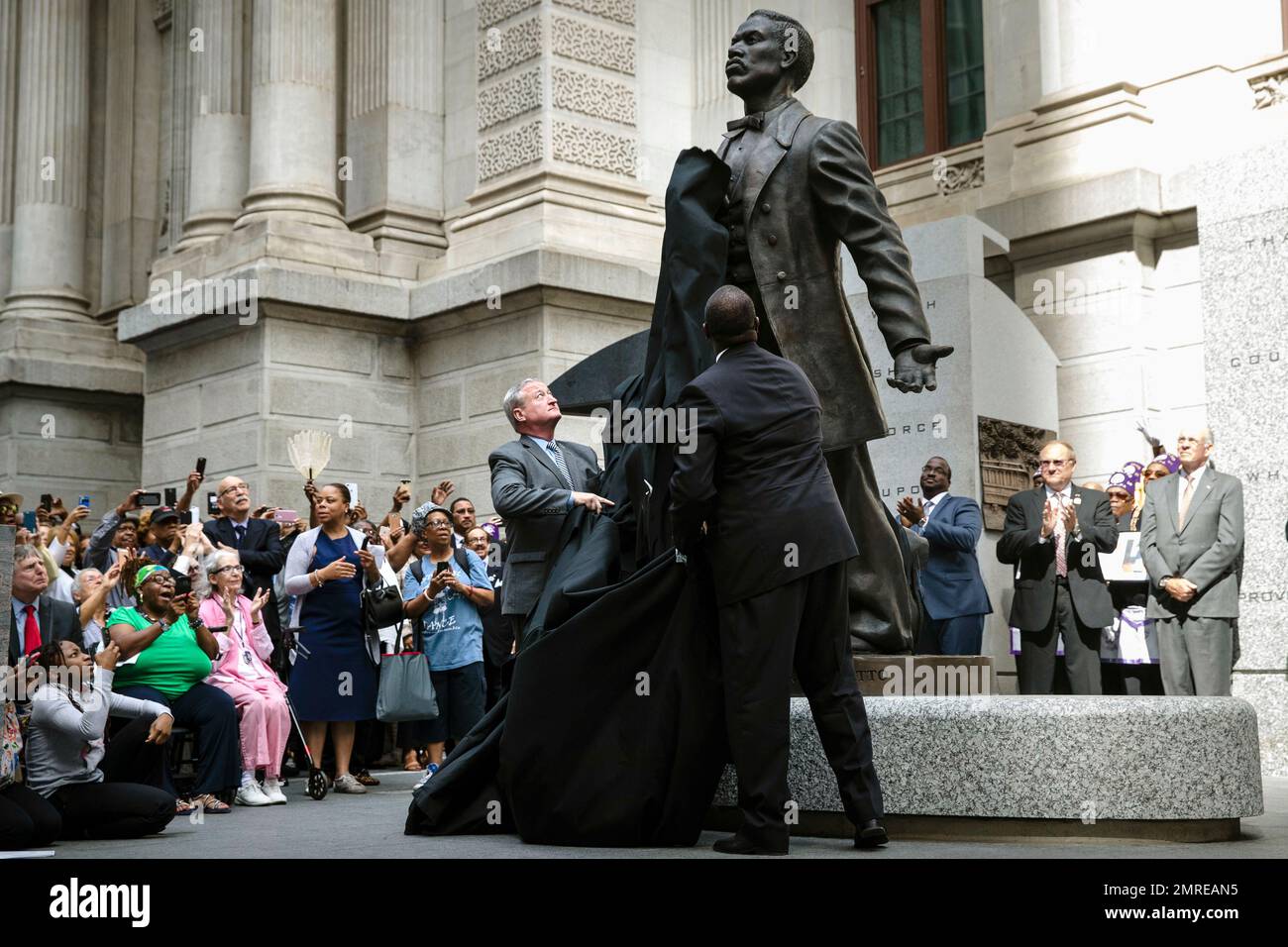 Philadelphia Mayor Jim Kenney, center, and sculptor Branly Cadet unveil ...