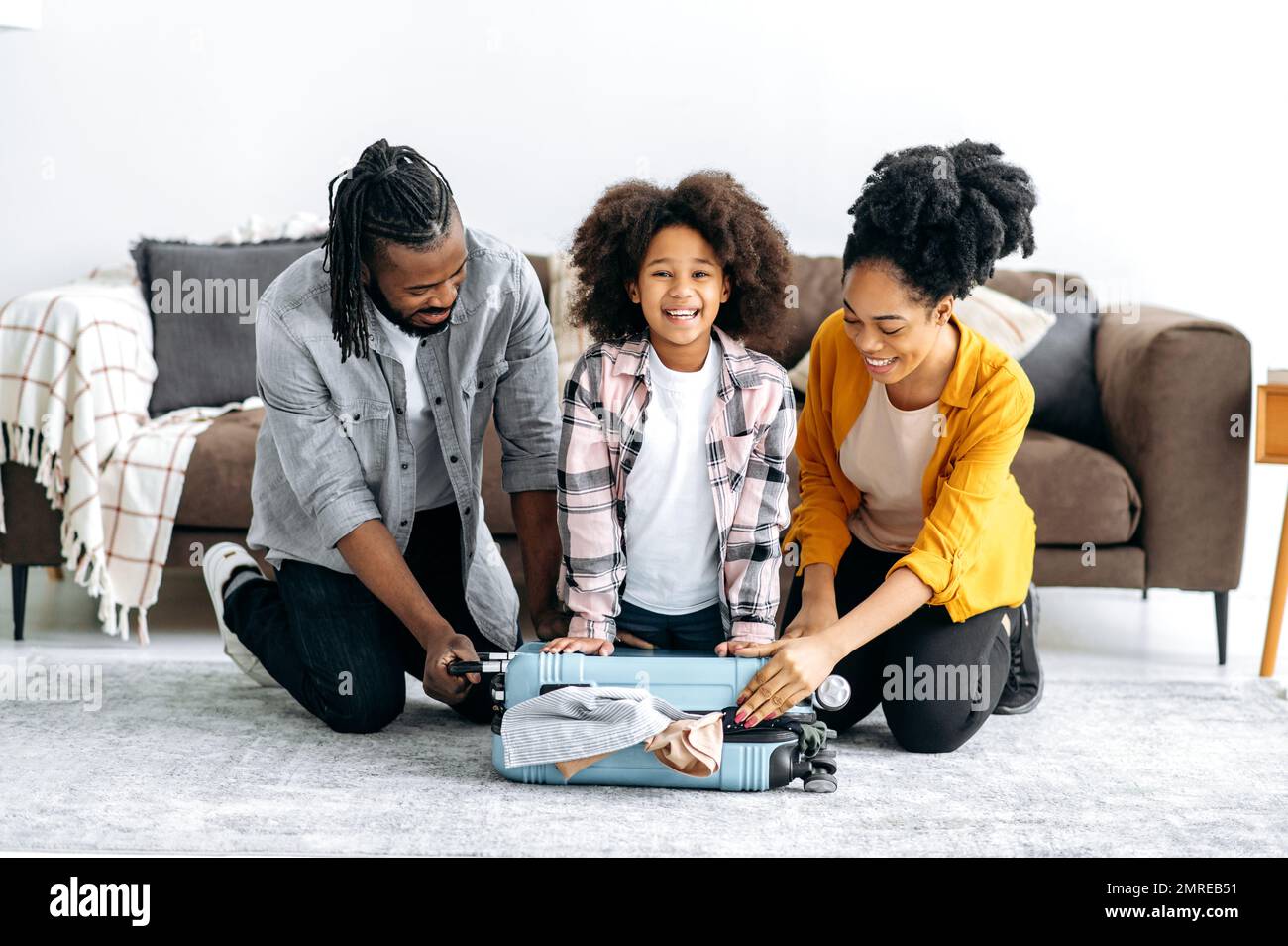 Happy african american family of three going to travel. Cheerful dad ...