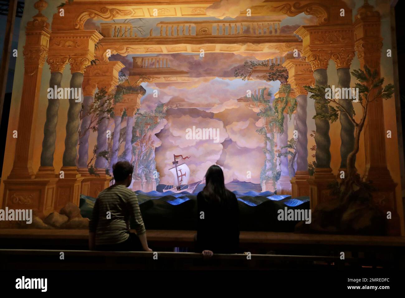 Staff members pose for photographs in front of a 2017 scenographic ...
