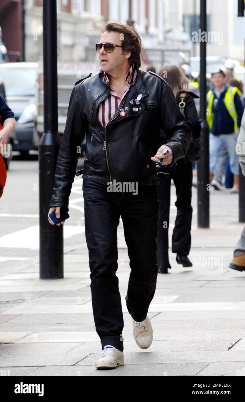 TV and radio presenter Jonathan Ross flashes a peace sign and says ...