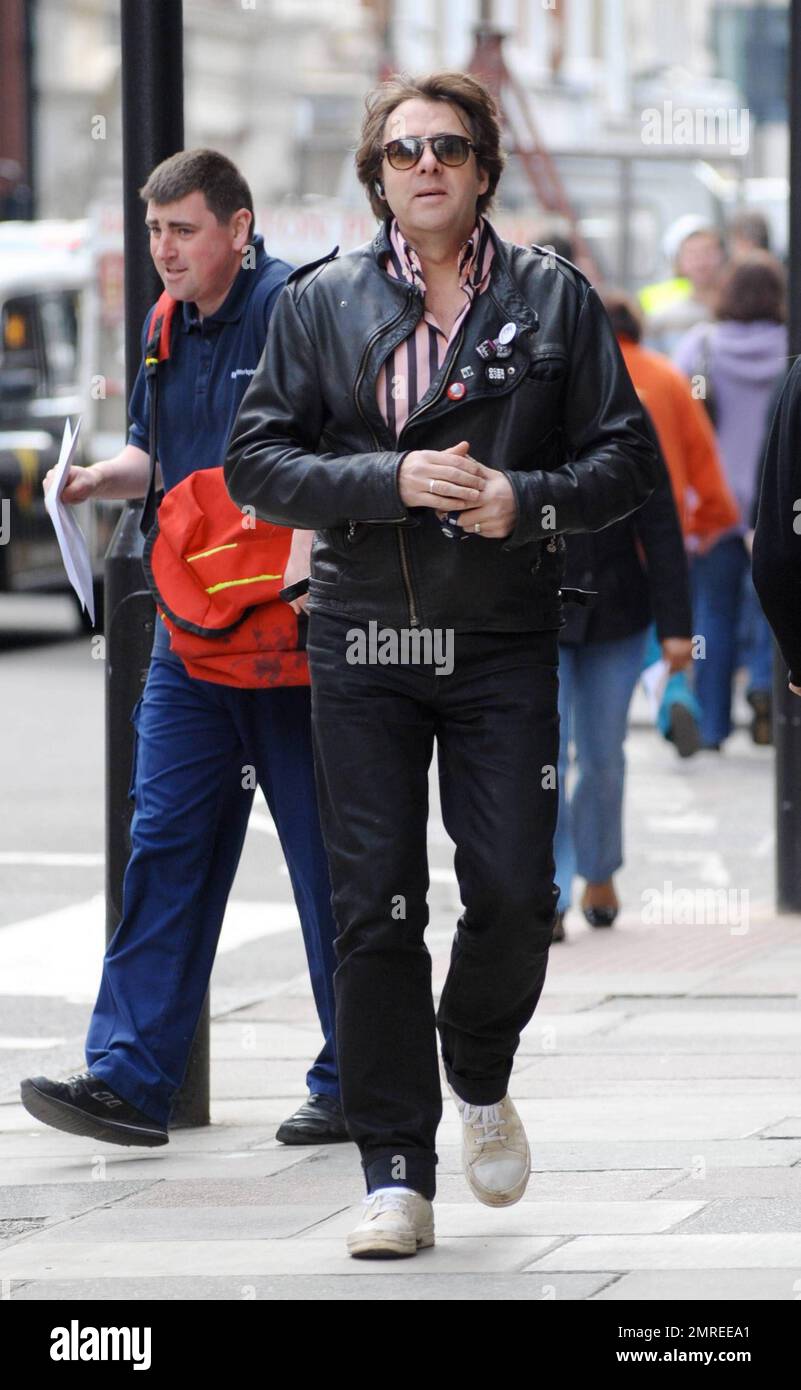 TV and radio presenter Jonathan Ross flashes a peace sign and says ...