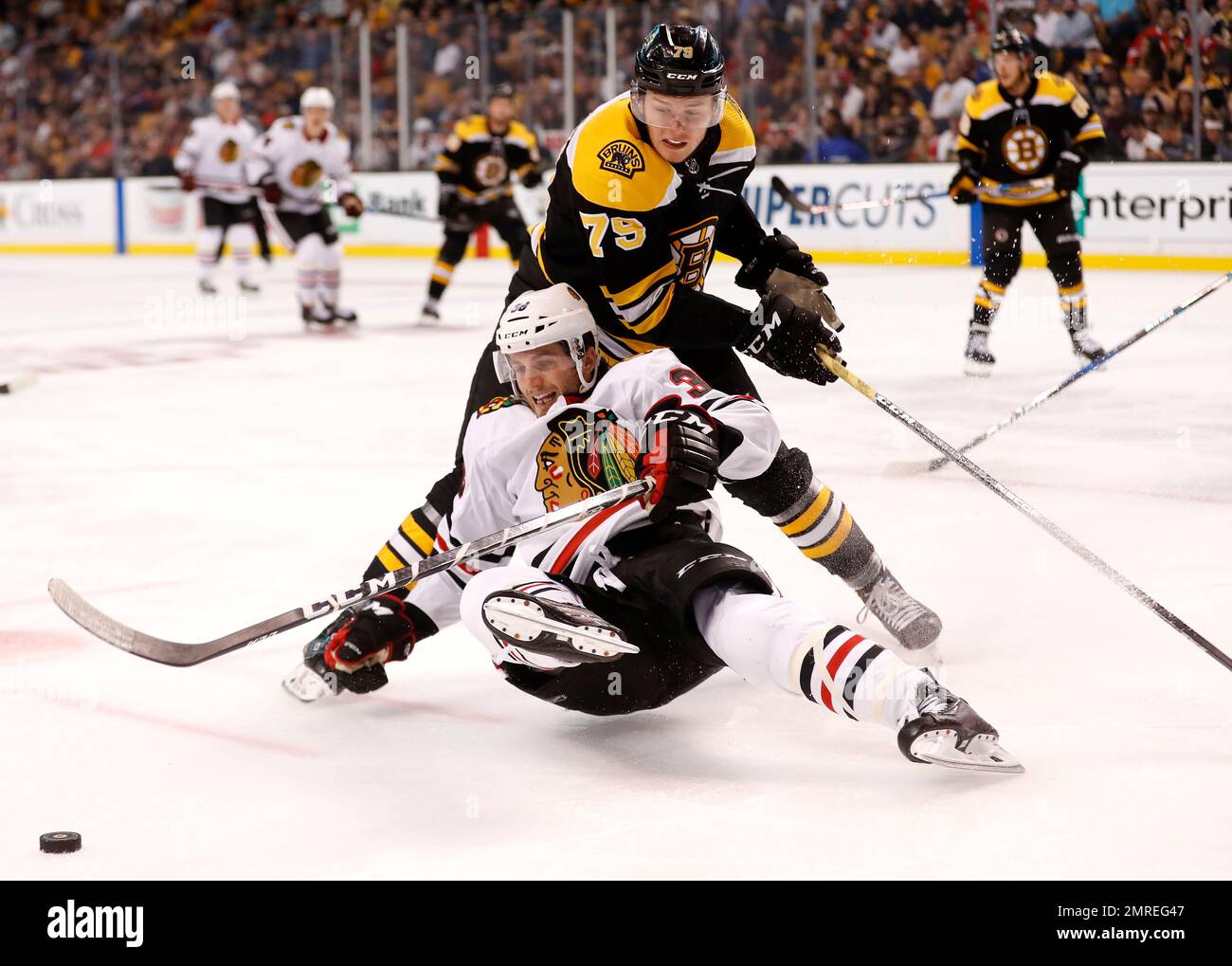 Chicago Blackhawks right wing Ryan Hartman is spilled by Boston Bruins ...