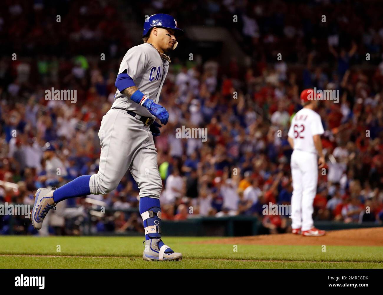 Chicago Cubs' Javier Baez, left, rounds the bases after hitting a three ...