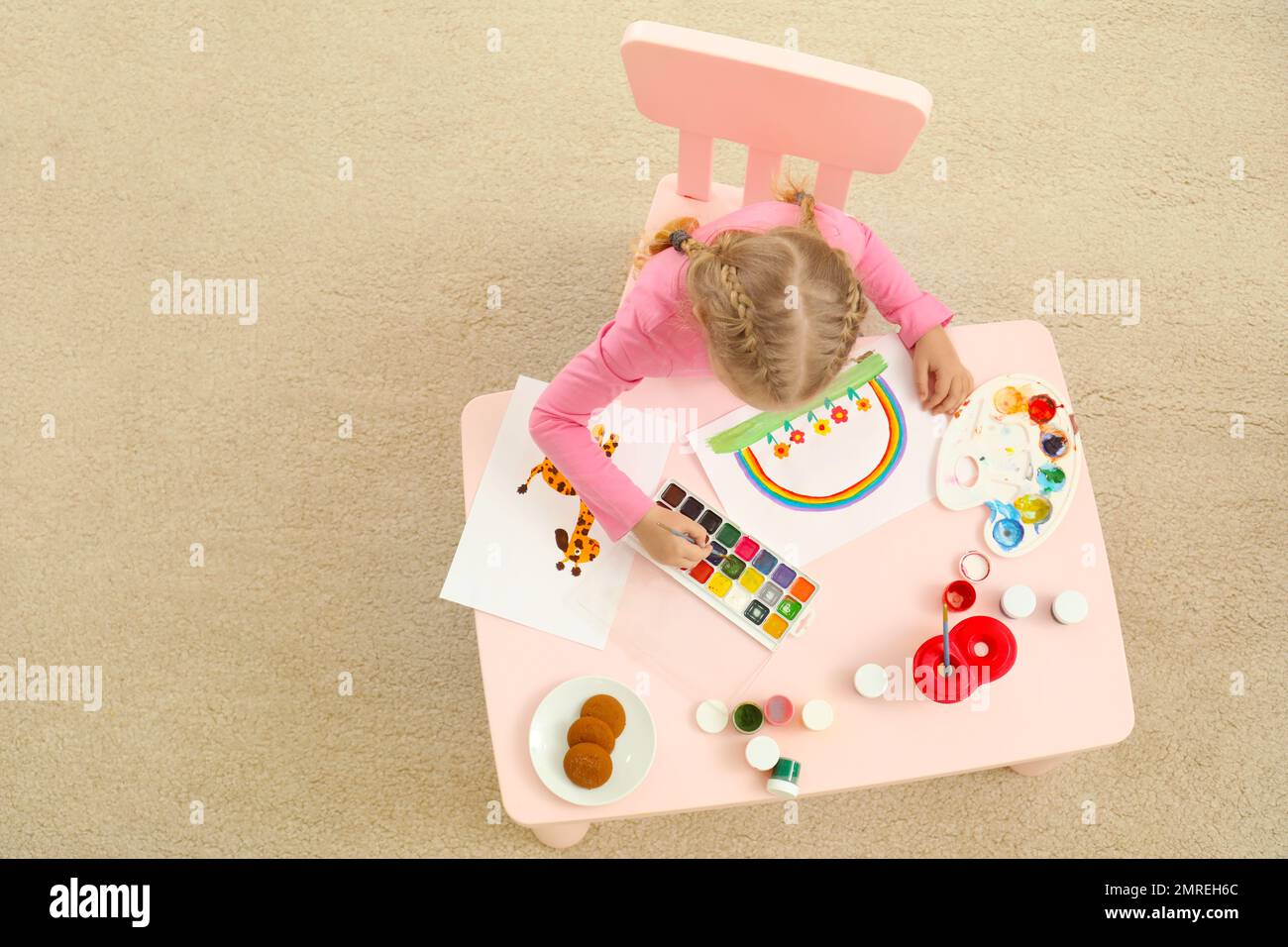 Cute little child painting at table, top view Stock Photo - Alamy