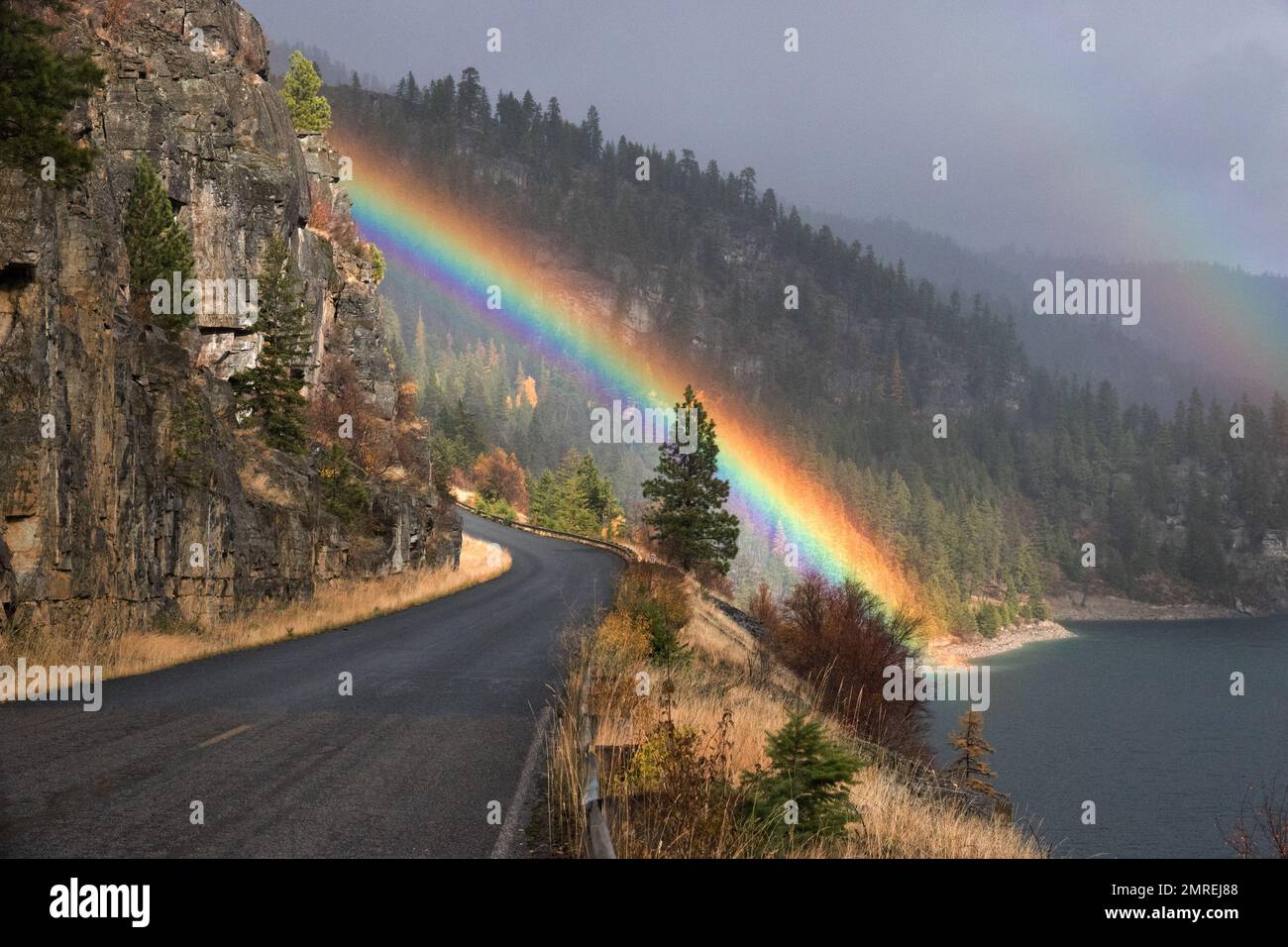 A beautiful nature scene after rain with a highway surrounded by cliffs ...