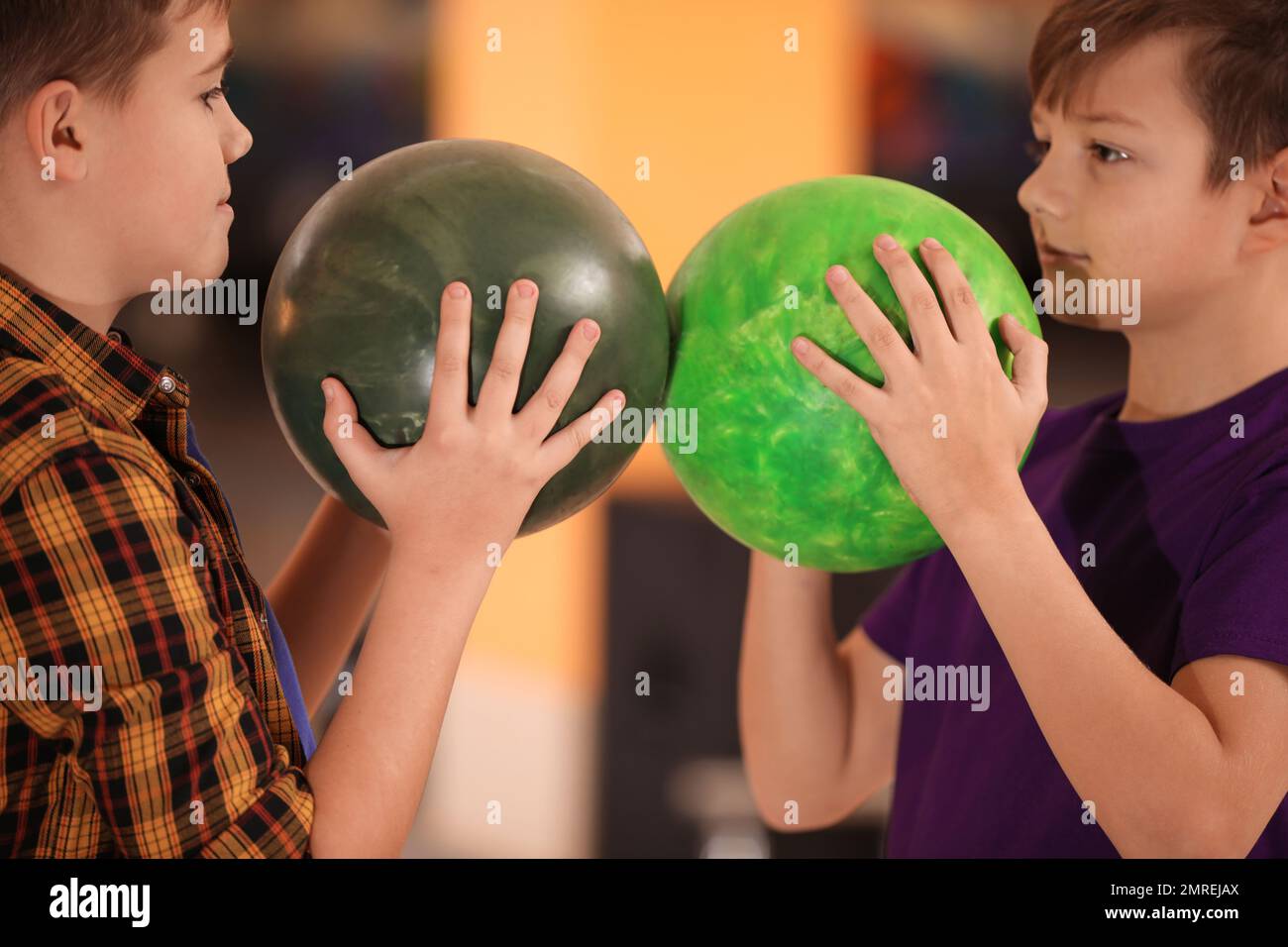 Happy boys with balls in bowling club Stock Photo - Alamy