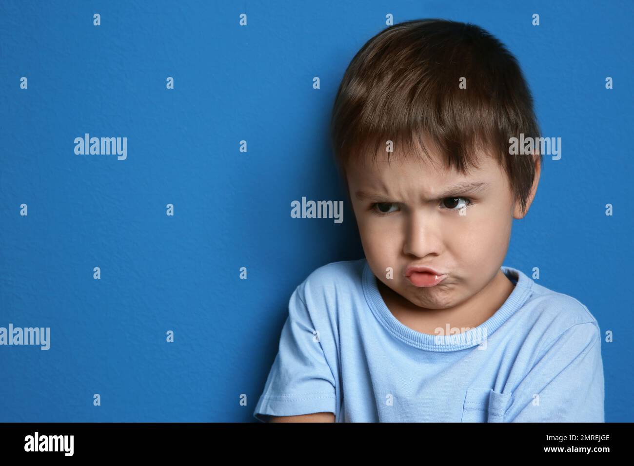 Portrait of emotional little boy on blue background Stock Photo - Alamy