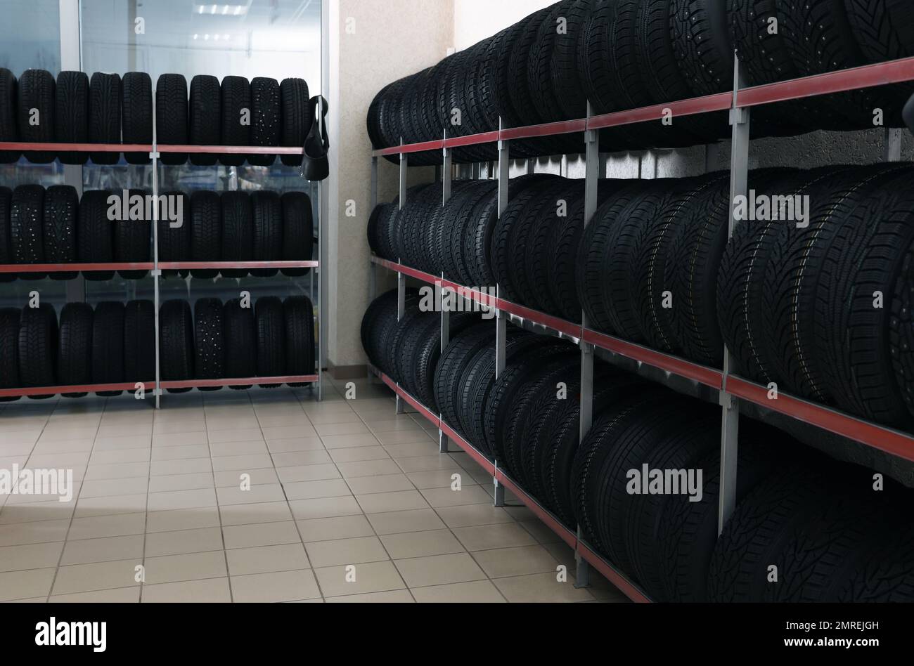 Car tires on rack in auto store Stock Photo - Alamy