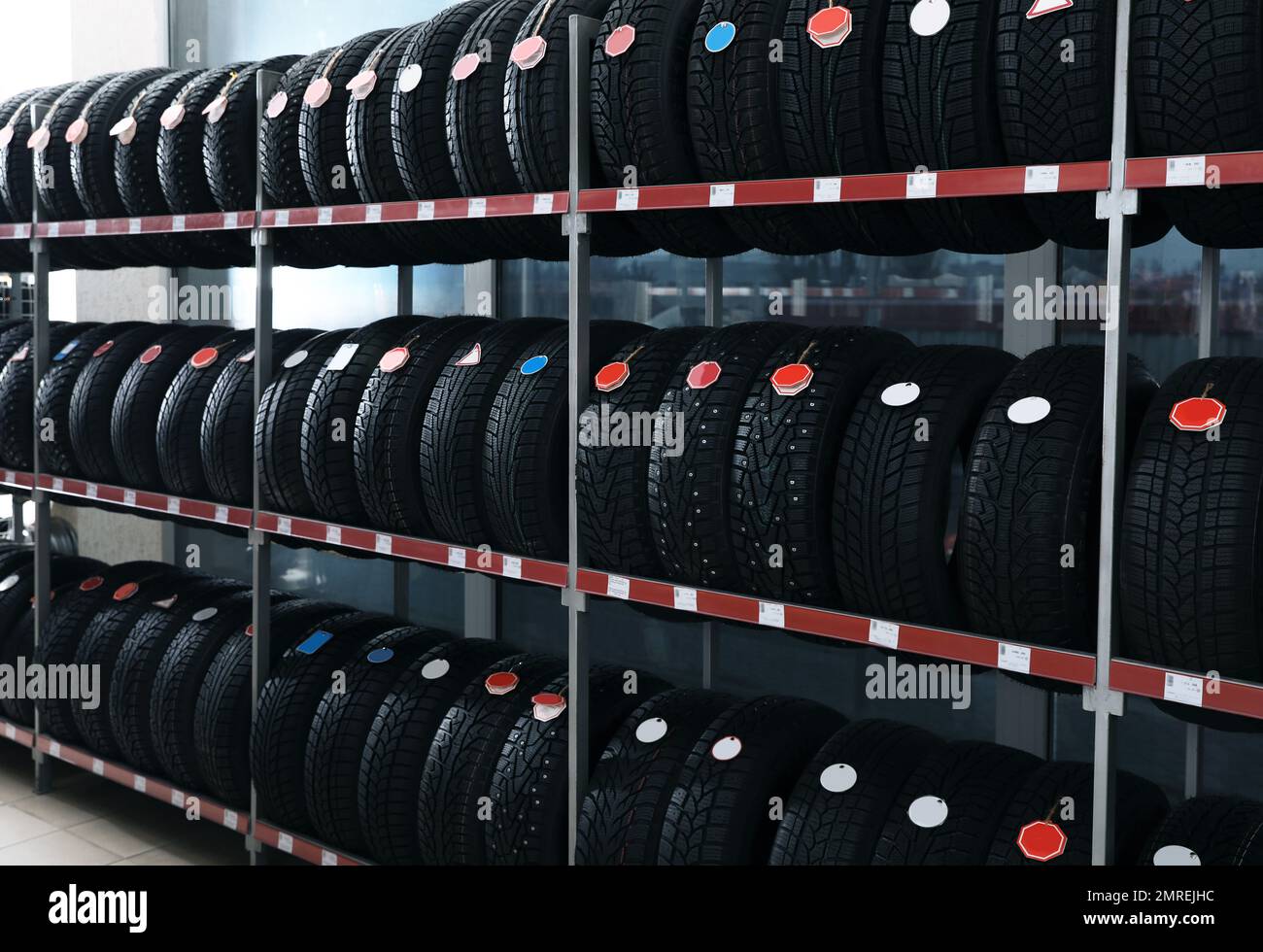 Car tires on rack in auto store Stock Photo - Alamy