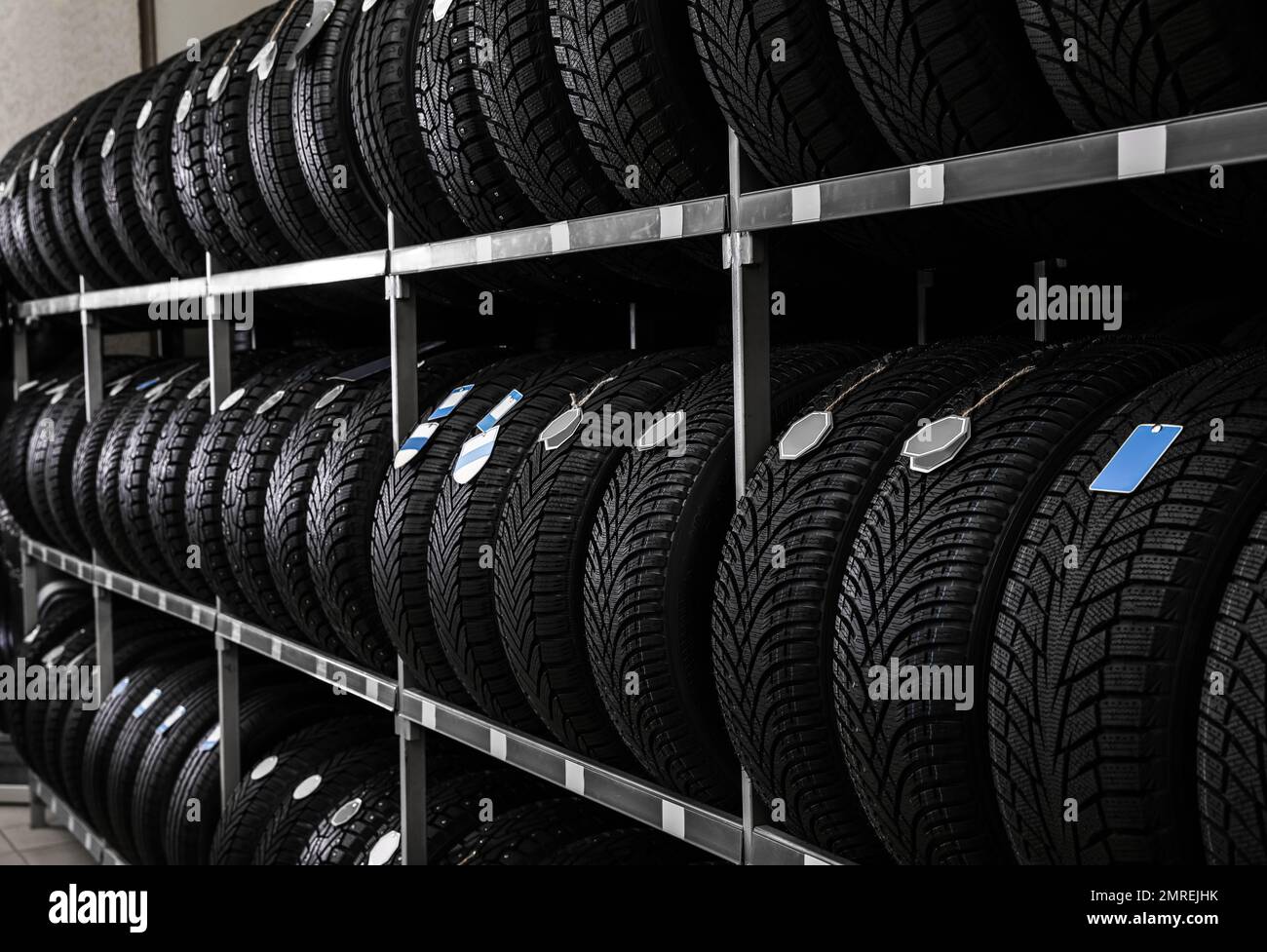 Car tires on rack in auto store Stock Photo - Alamy