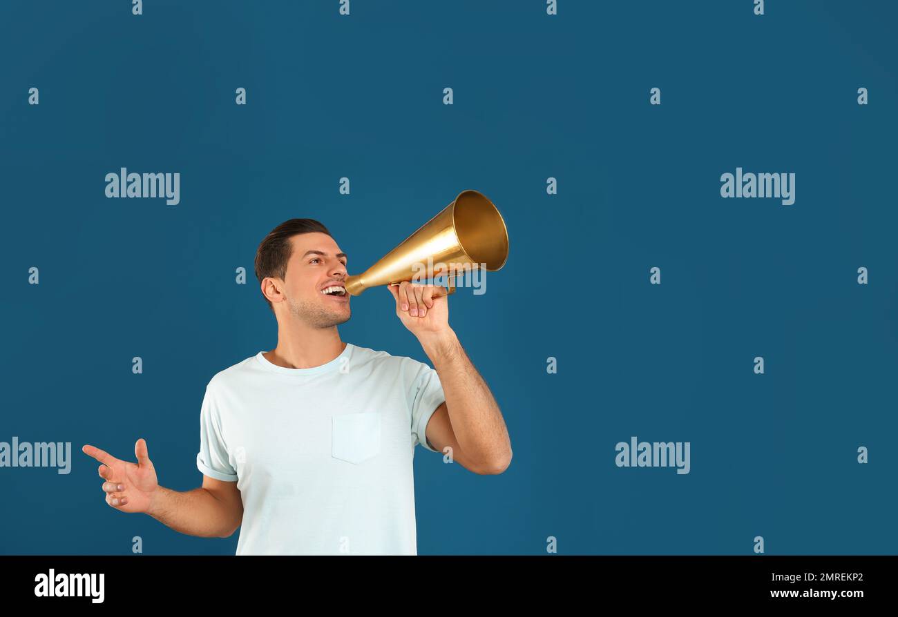 Smiling handsome man megaphone hi-res stock photography and images - Alamy