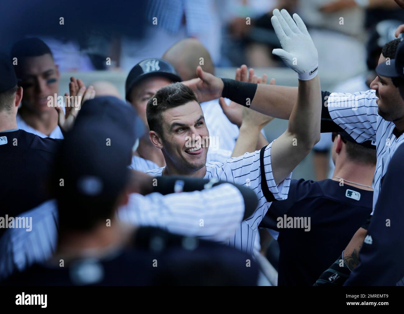 New York Yankees' Greg Bird celebrates his two-run homer in the dugout ...