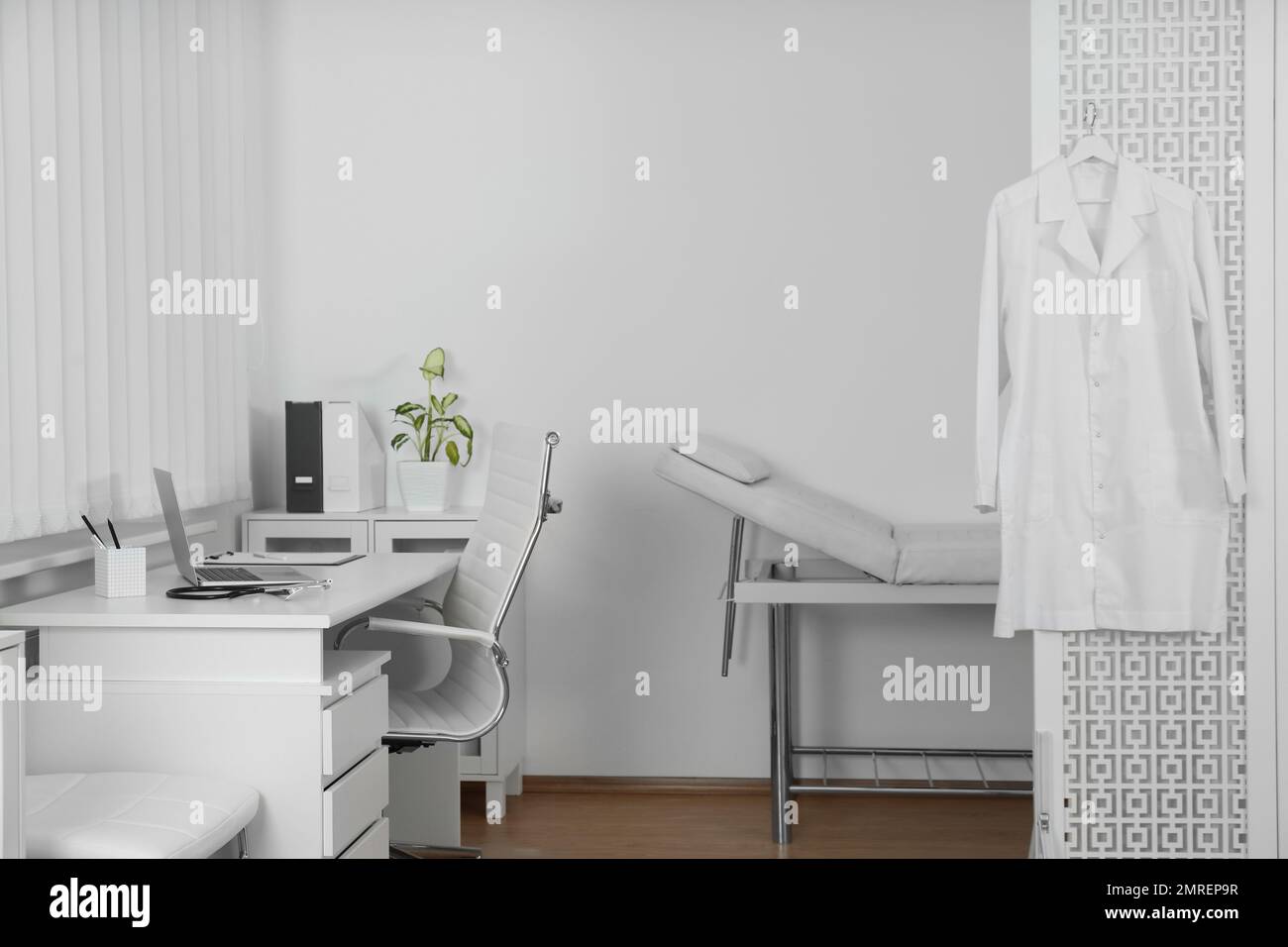 Doctor's office interior with desk and examination couch Stock Photo ...