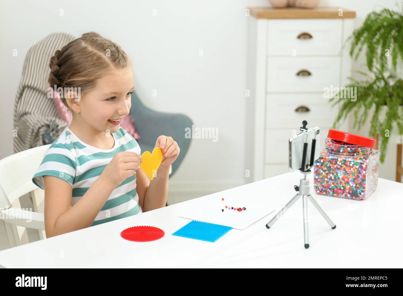 Cute little blogger with handcrafting recording video at home Stock ...
