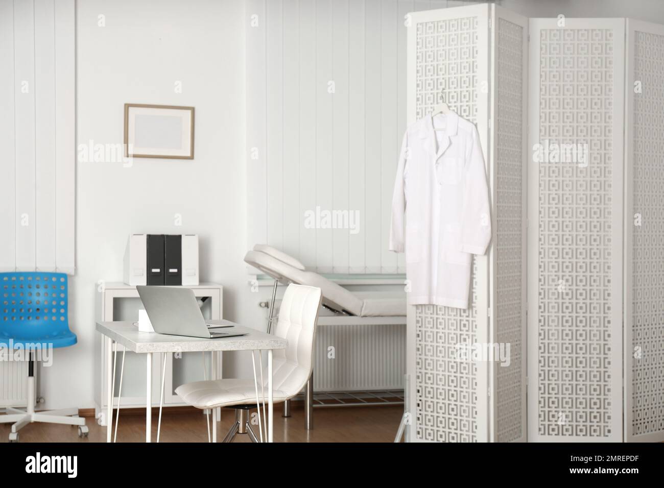 Doctor's office interior with desk, examination couch and folding ...