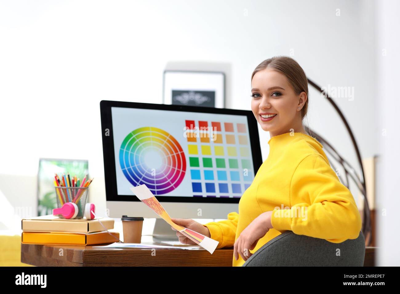 Professional designer with color palettes at workplace in office Stock ...