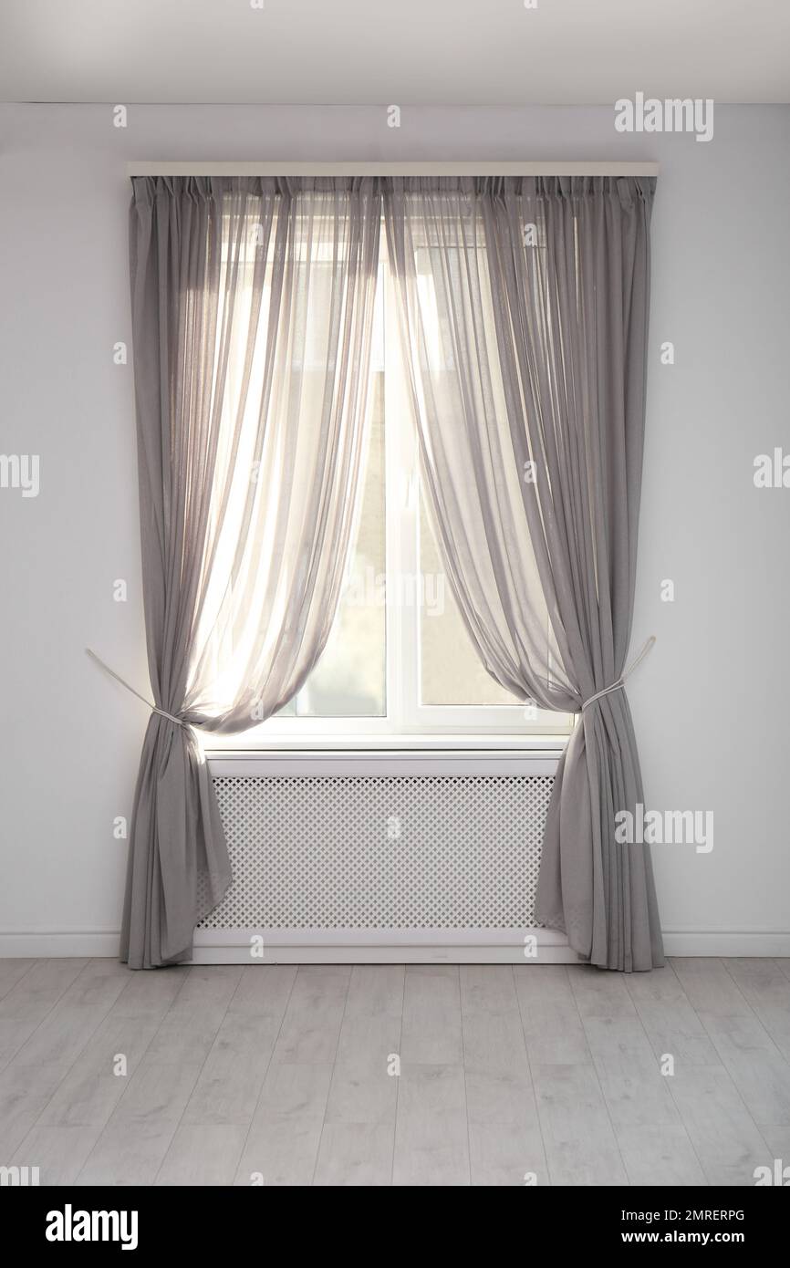 Window with beautiful curtains in empty room Stock Photo - Alamy