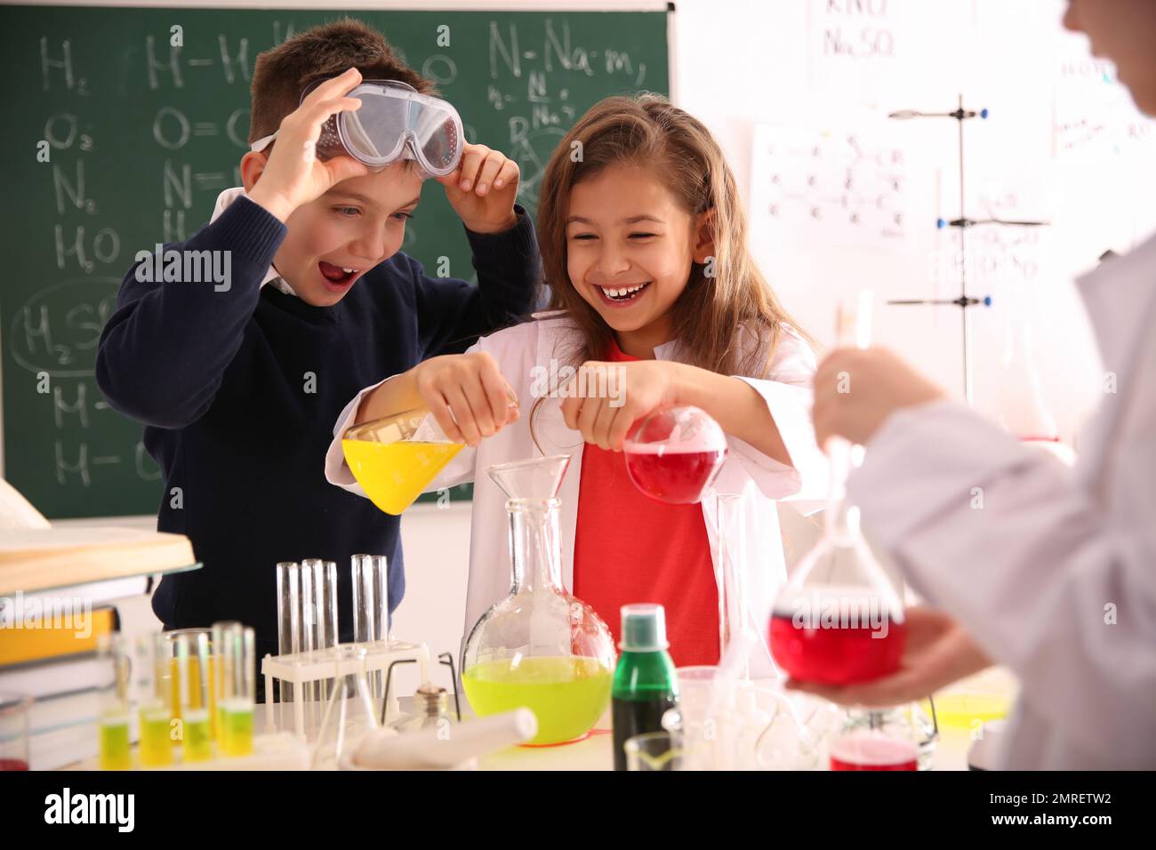 Smart pupils making experiment in chemistry class Stock Photo - Alamy