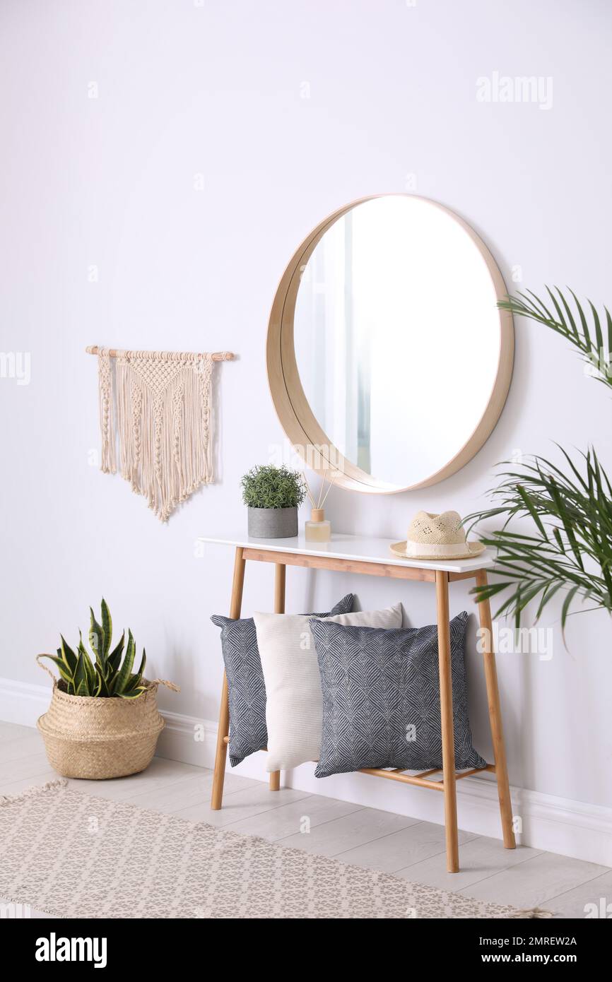 Round mirror and wooden table at home. Idea for interior design Stock ...